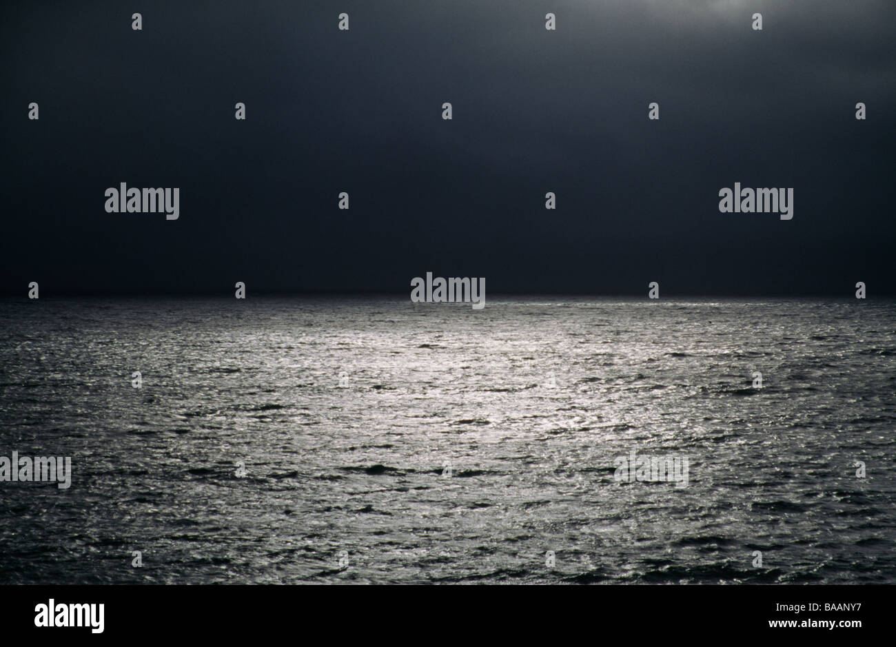 Moonlight reflection on sea water at night Stock Photo - Alamy