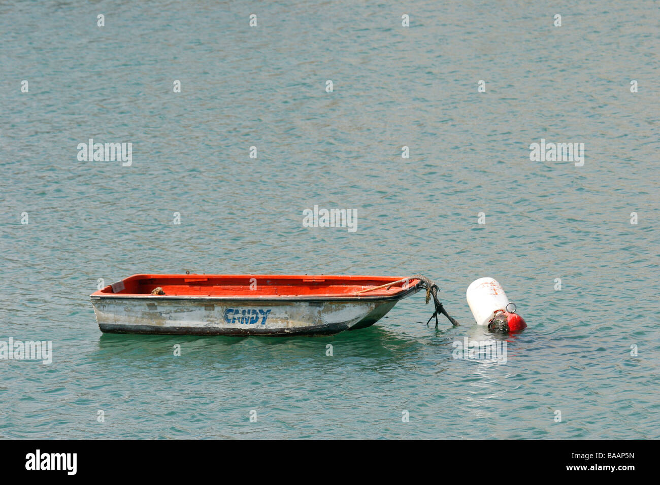 A small boat floats in the water in the west coast fishing town of ...