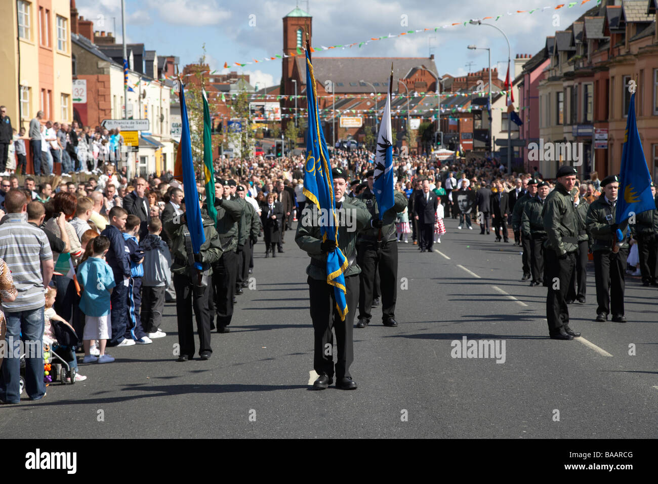 flag bearing colour party march along the falls road on Easter Sunday ...