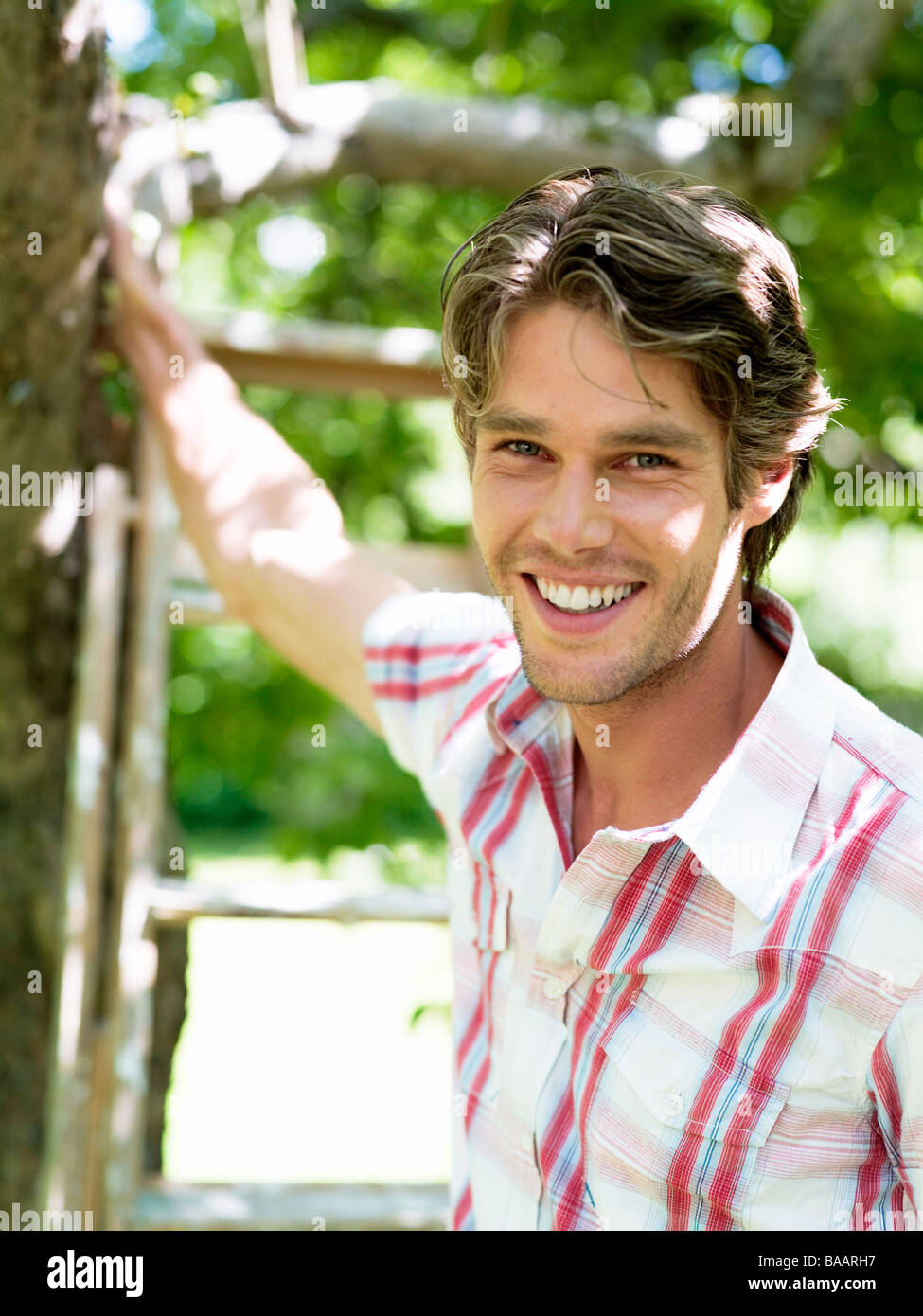 A smiling man standing in a garden, Stockholm, Sweden Stock Photo - Alamy