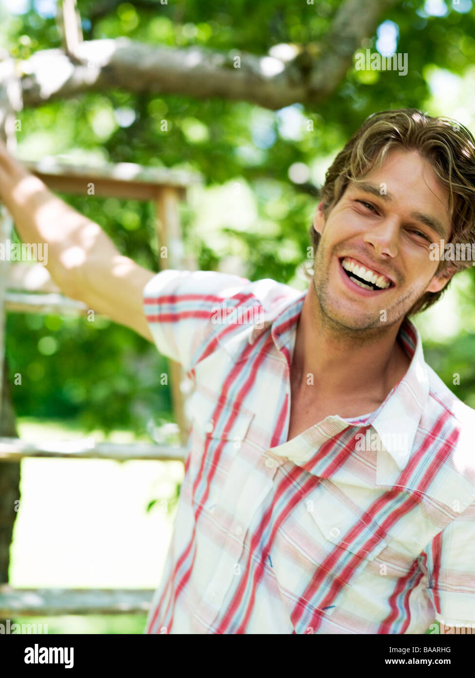 A smiling man standing in a garden, Stockholm, Sweden Stock Photo - Alamy