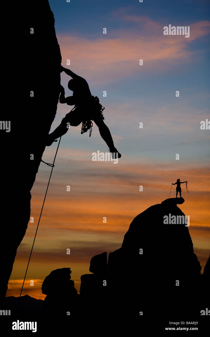 A rock climber clings to the side of an overhanging cliff Stock Photo ...