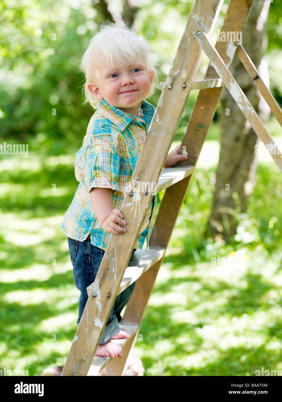 A boy climbing a ladder, Stockholm, Sweden Stock Photo - Alamy