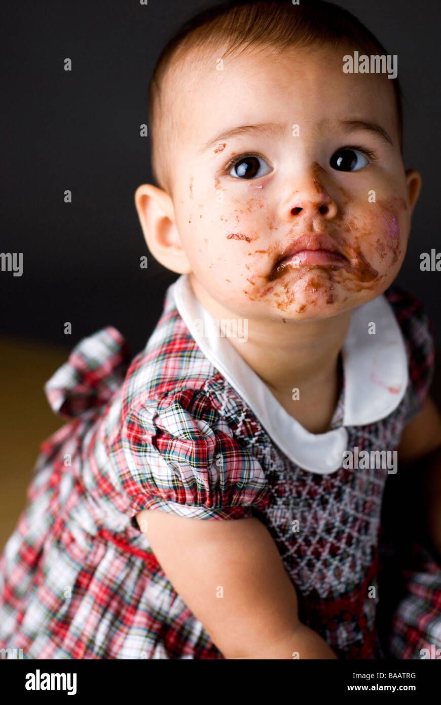 Adorable little girl with chocolate icing on her face Stock Photo - Alamy