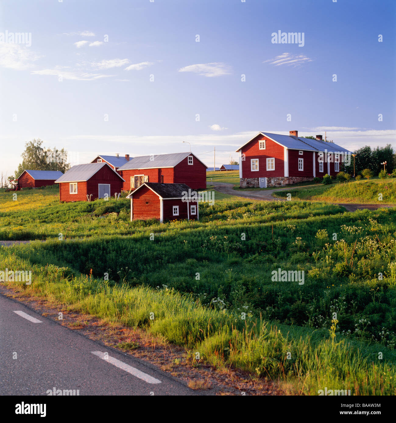 Houses by road on grassland Stock Photo - Alamy