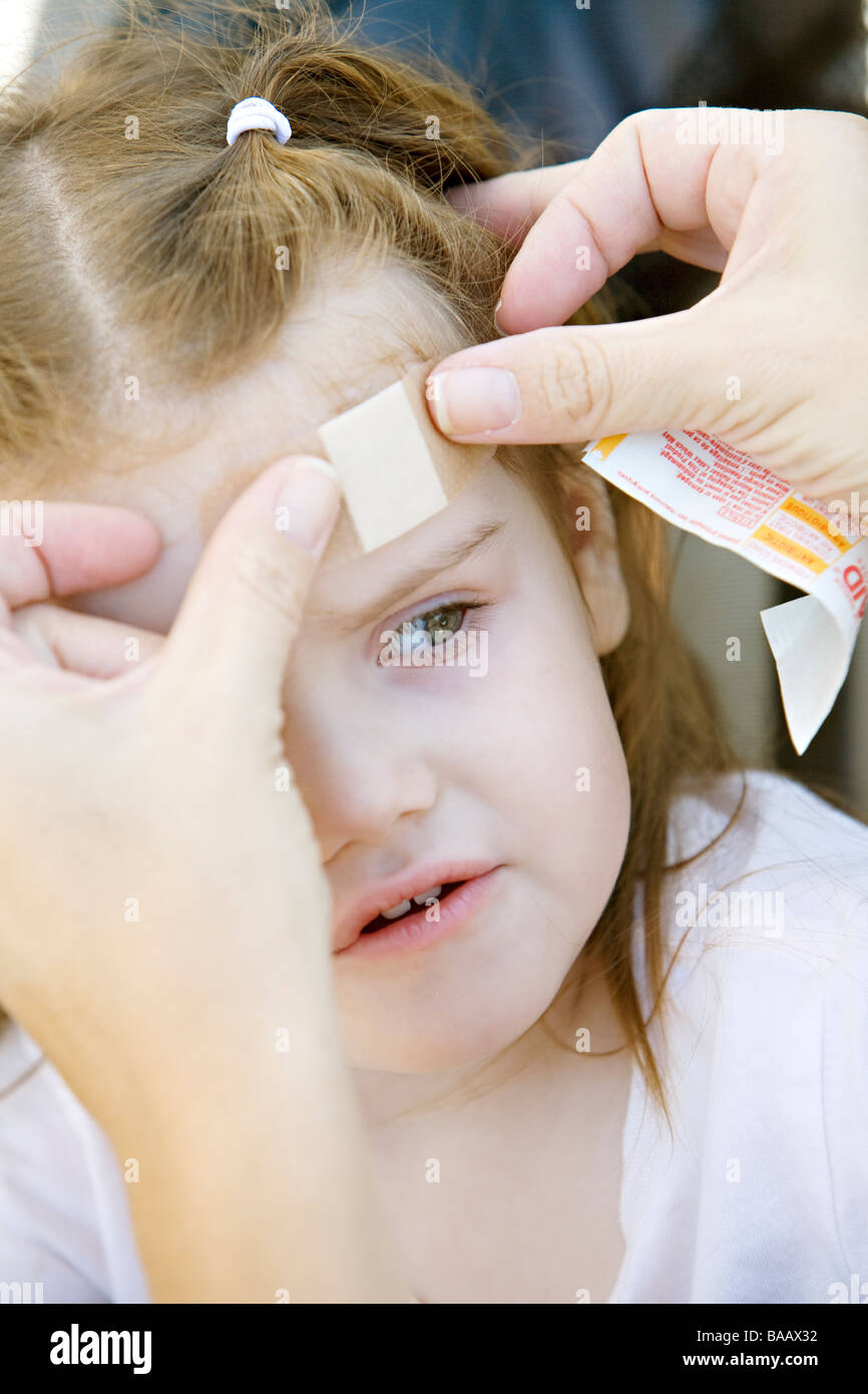 A Scandinavian mother giving her daughter a plaster, USA Stock Photo ...