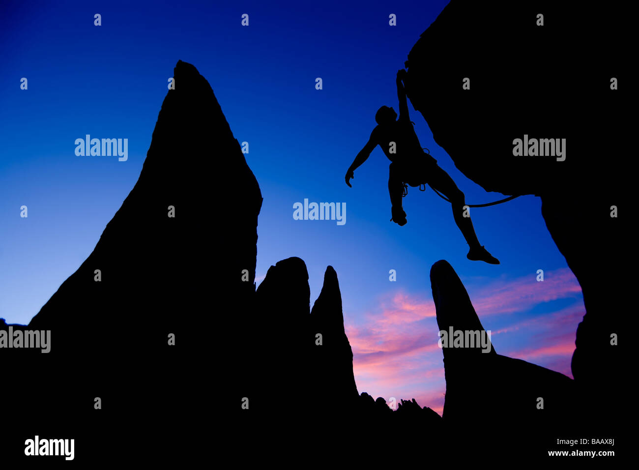 A rock climber clings to the side of an overhanging cliff Stock Photo ...