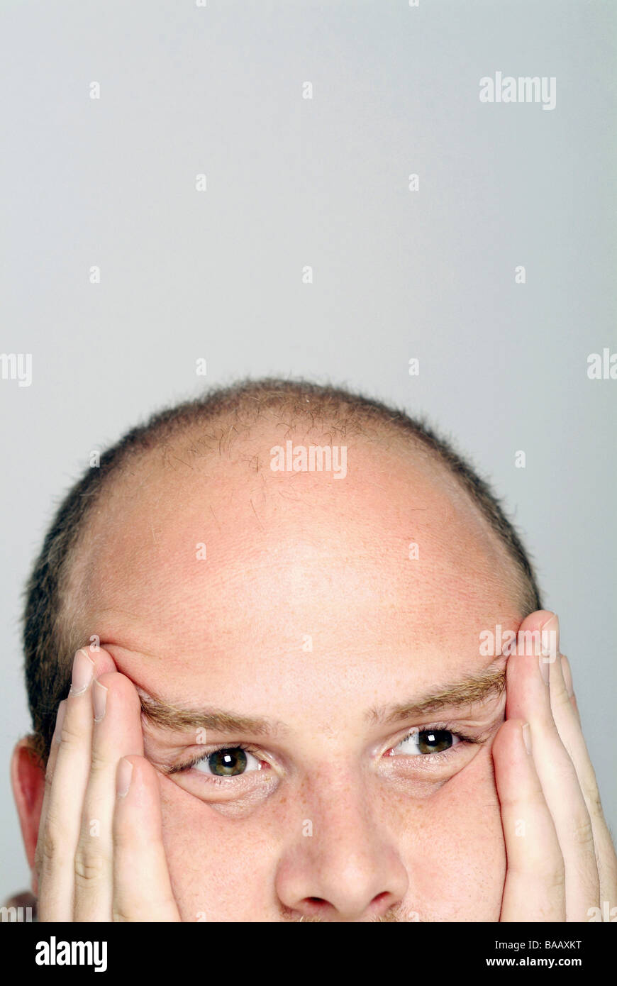 Man holding his face in his hands Stock Photo - Alamy
