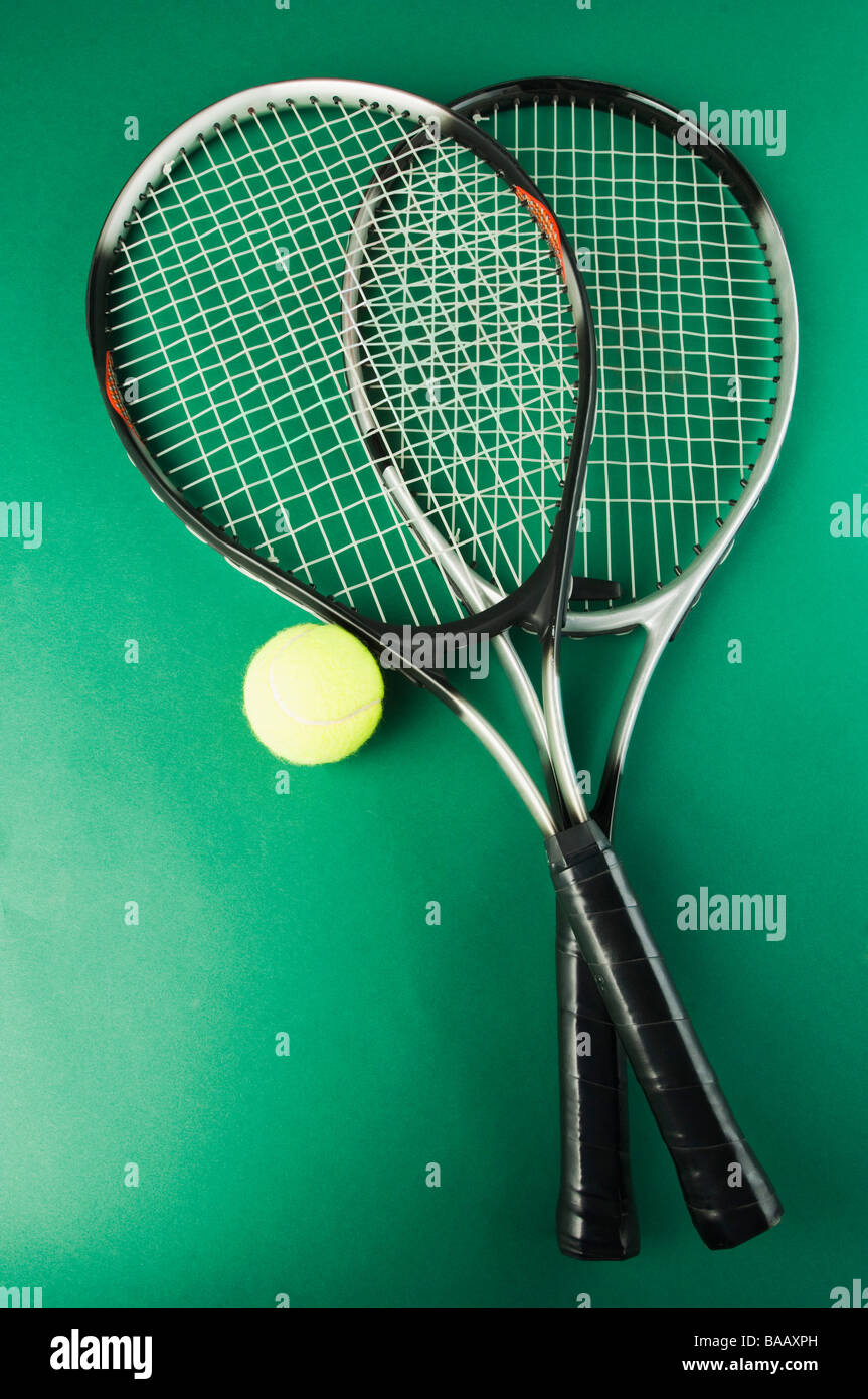 Close-up of two tennis rackets with a tennis ball Stock Photo - Alamy