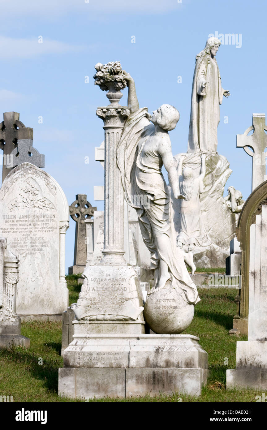 Marble Gravestone statues in graveyard with Jesus in background Stock ...