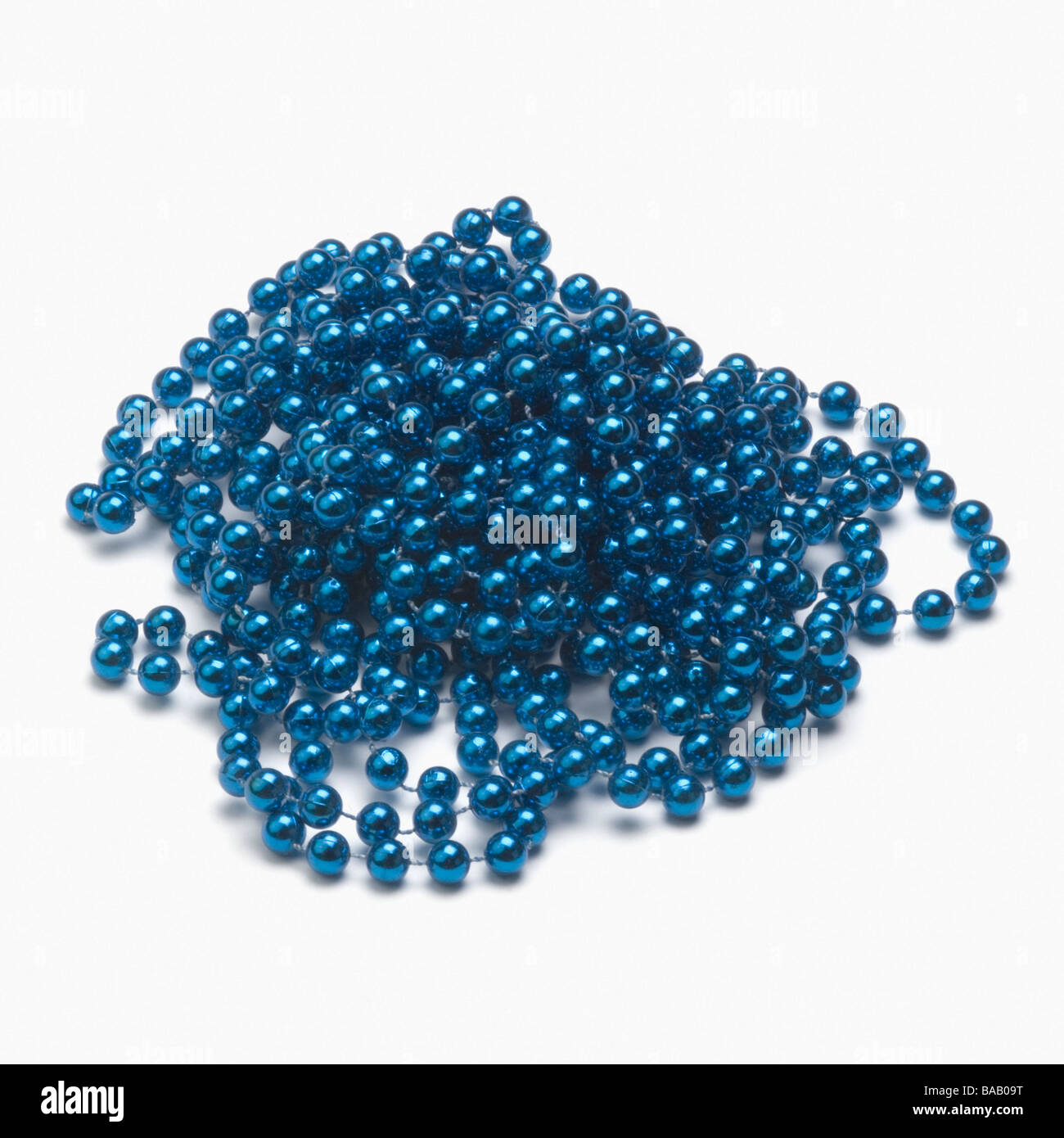String of blue beads on white background Stock Photo - Alamy