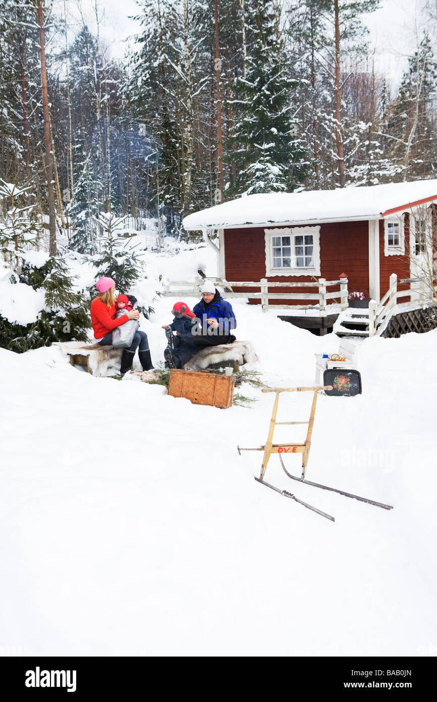 A family having a picnic in the snow, Sweden Stock Photo - Alamy