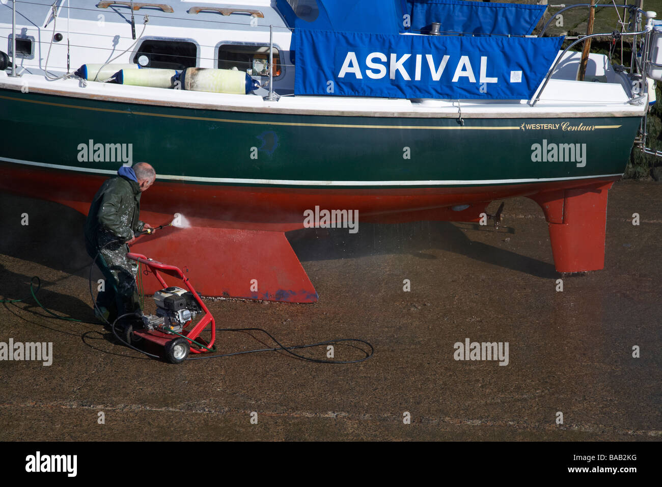 man cleaning the hull defouling the underside of his westerly centaur ...