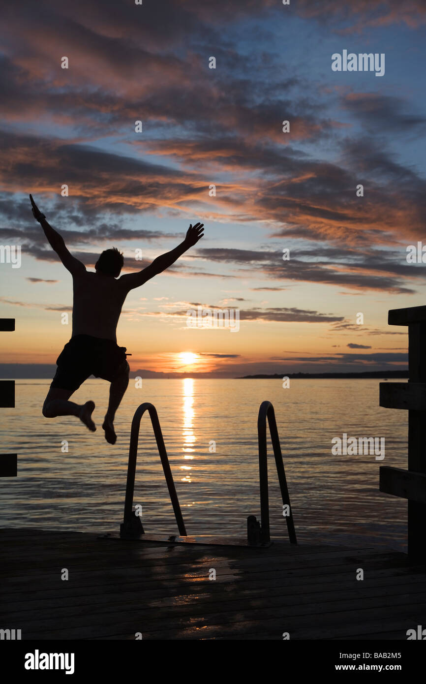 A man jumping into the ocean, Skane, Sweden Stock Photo - Alamy