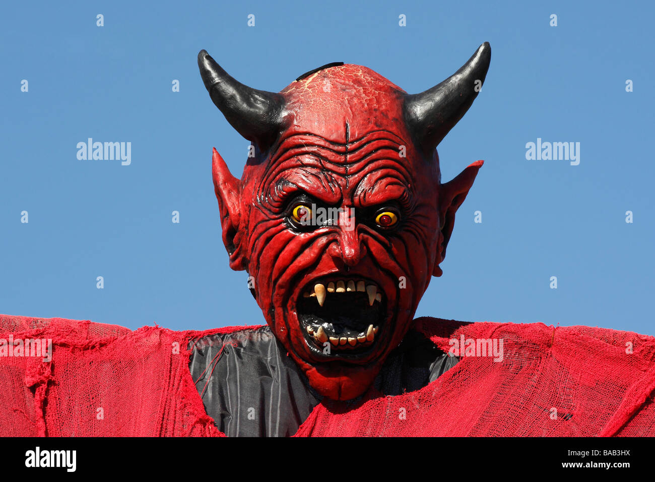 Halloween spooky scary face of red devil mask dummy dressed in Autumn ...