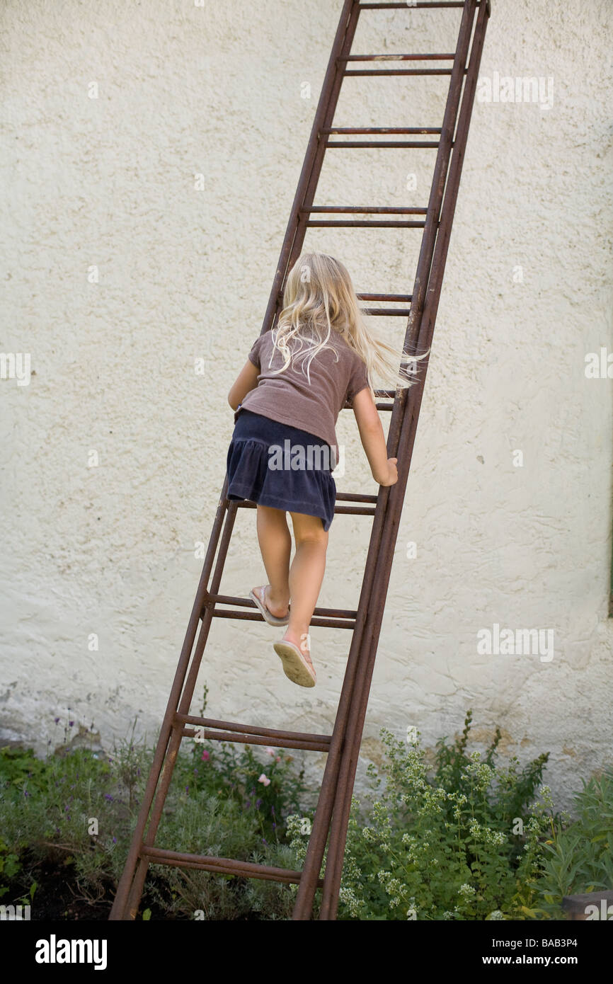 A girl climbing a ladder, Gotland, Sweden Stock Photo - Alamy
