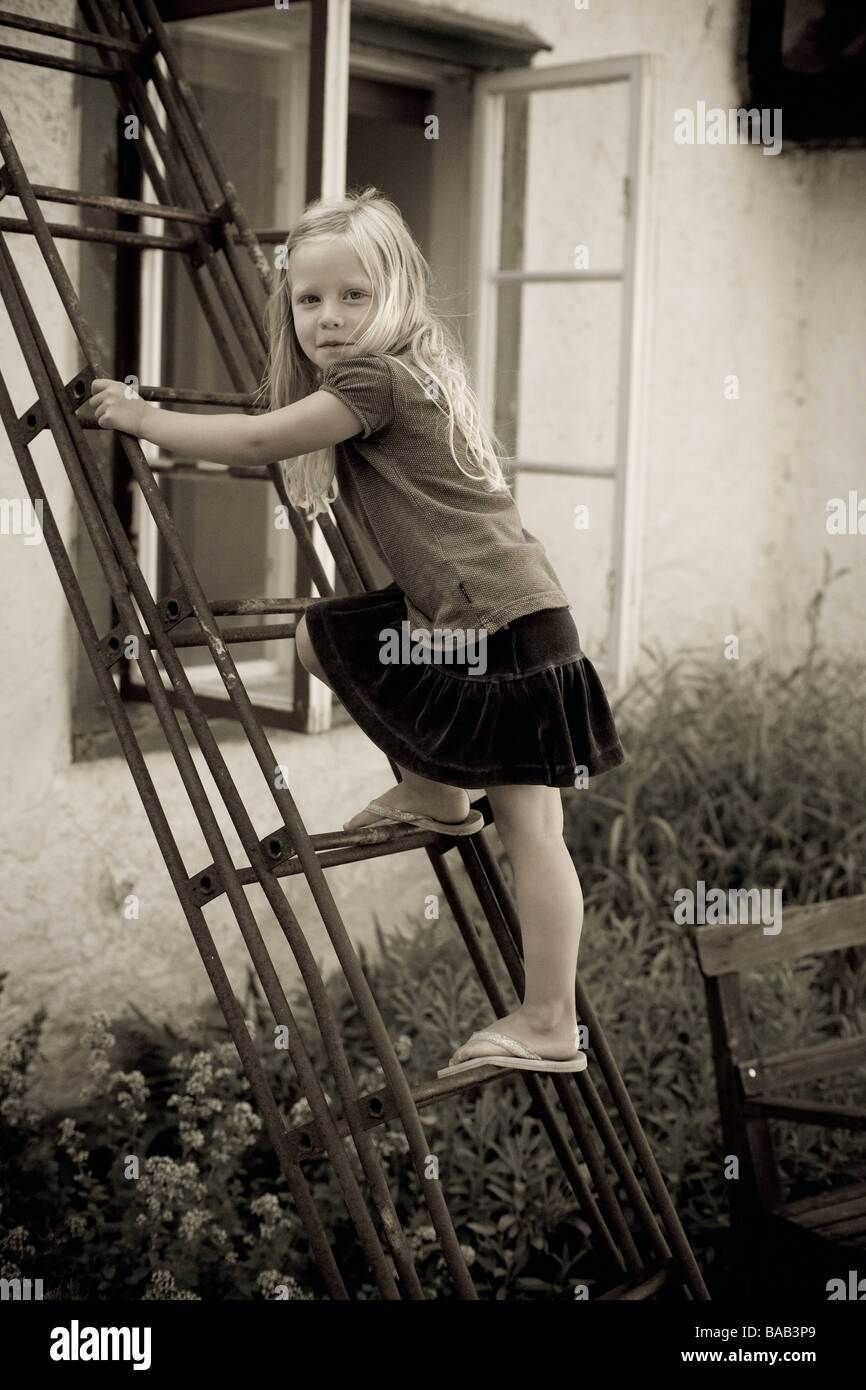 A girl climbing a ladder, Gotland, Sweden Stock Photo - Alamy