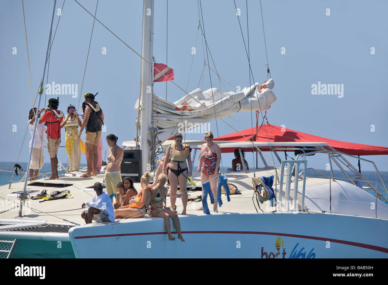 Tourists enjoying the sunshine on a catamaran cruise, West Coast of ...