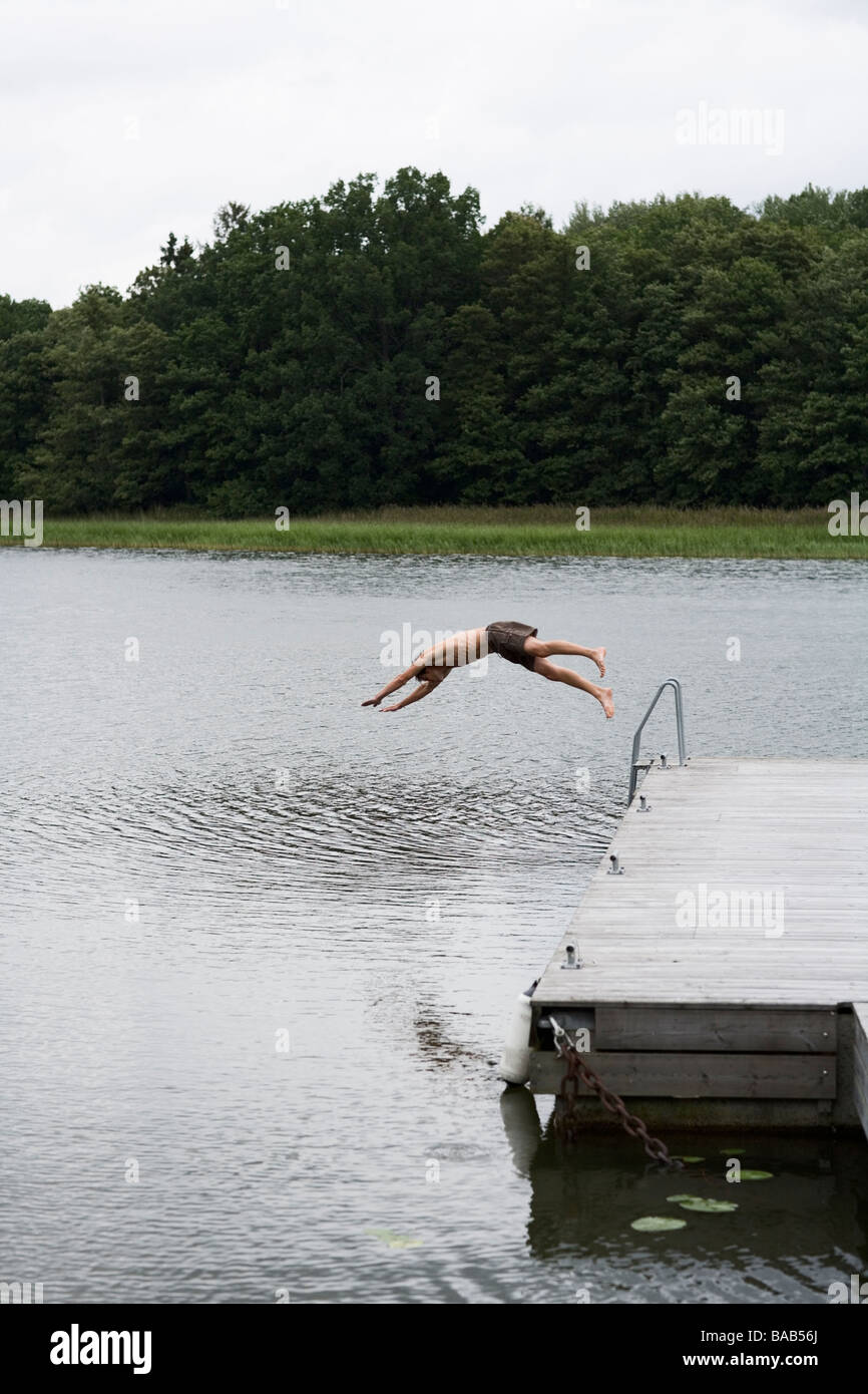A man diving into the water, Sweden Stock Photo - Alamy