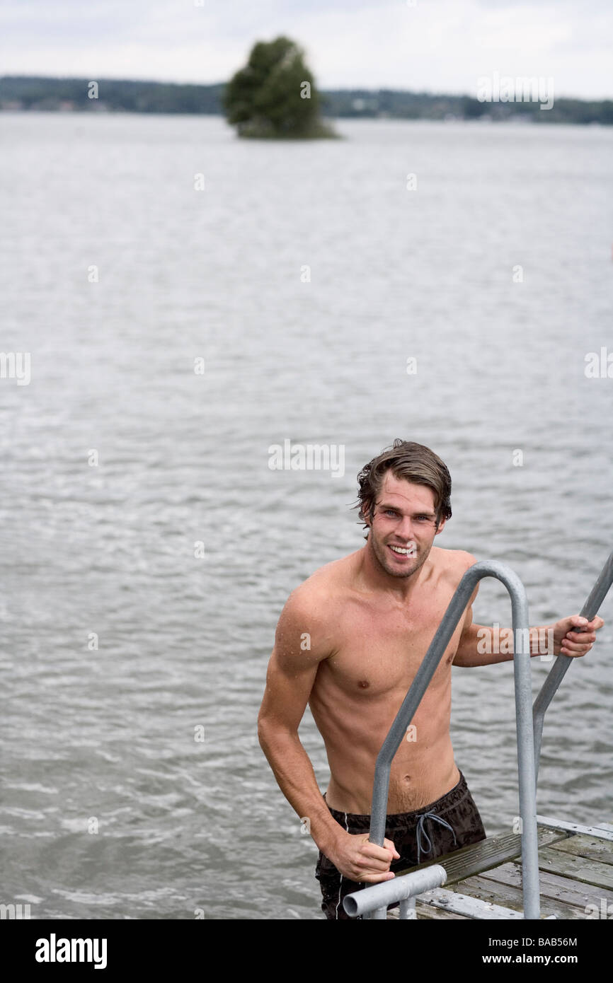 A man climbing up a ladder, Sweden Stock Photo - Alamy