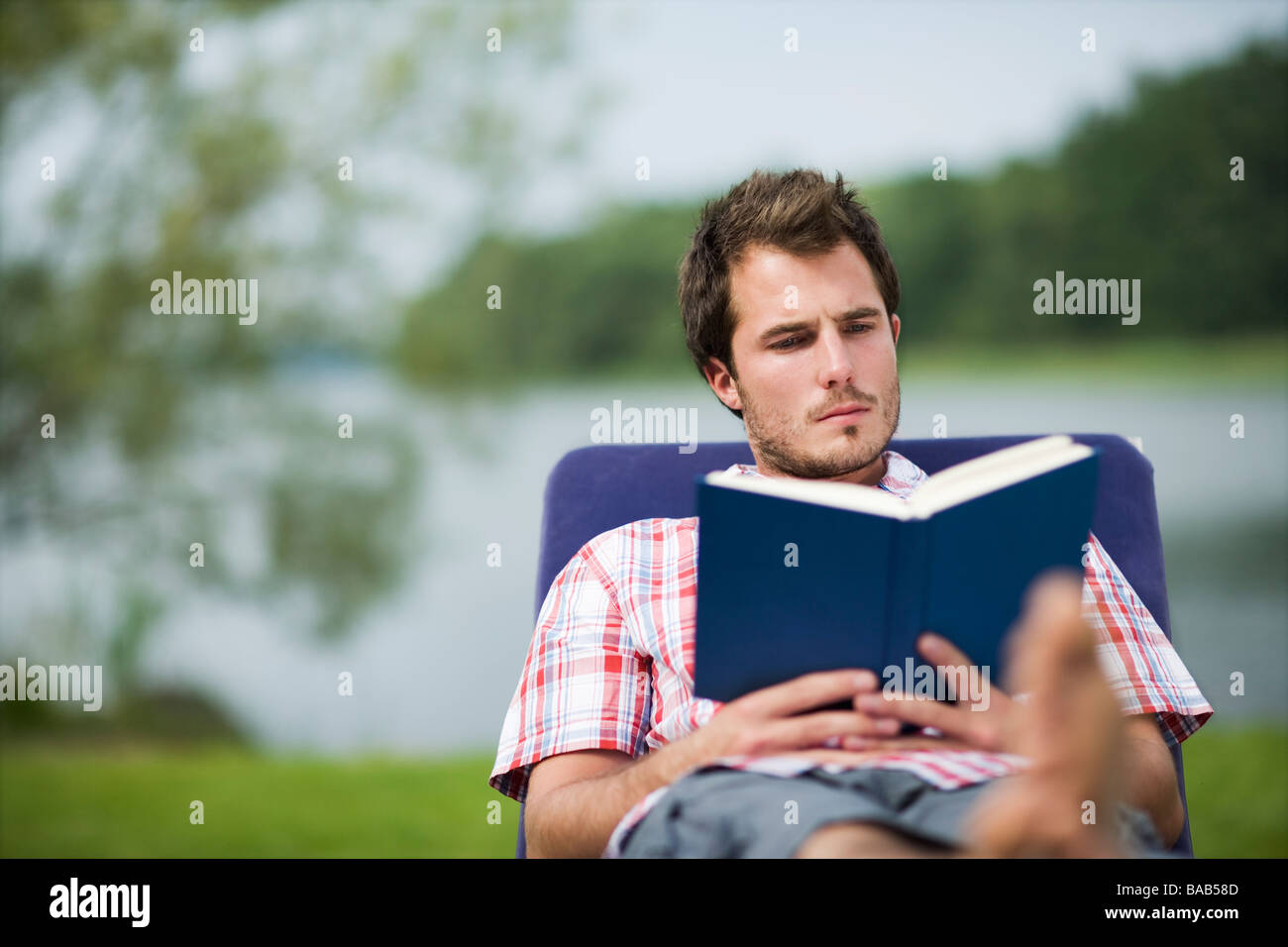 A man reading a book, Sweden Stock Photo - Alamy
