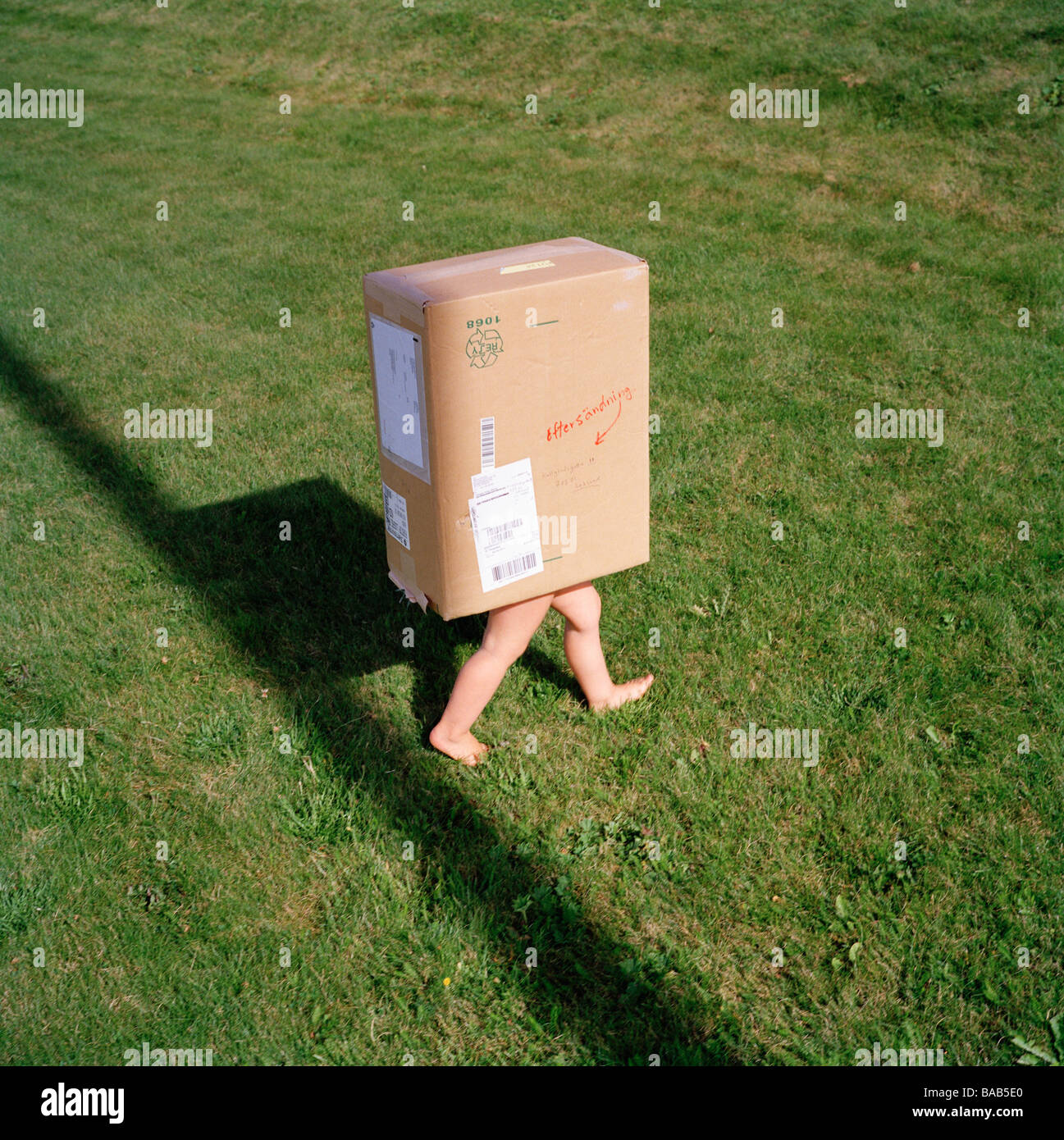 A Little Child Walking With A Carton Over The Head Sweden Stock Photo ...