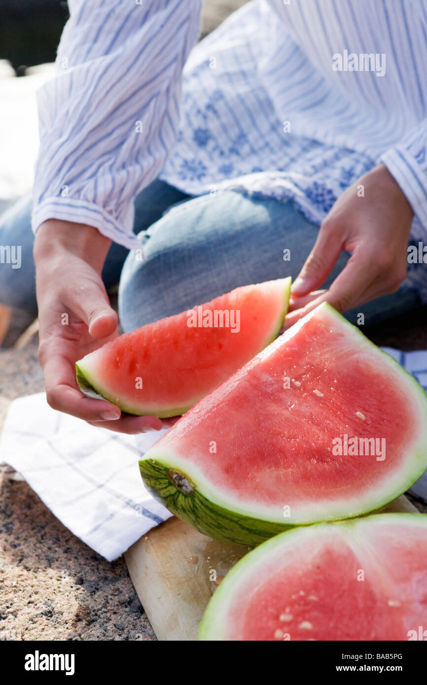 A woman cutting up a watermelon, Sweden Stock Photo - Alamy