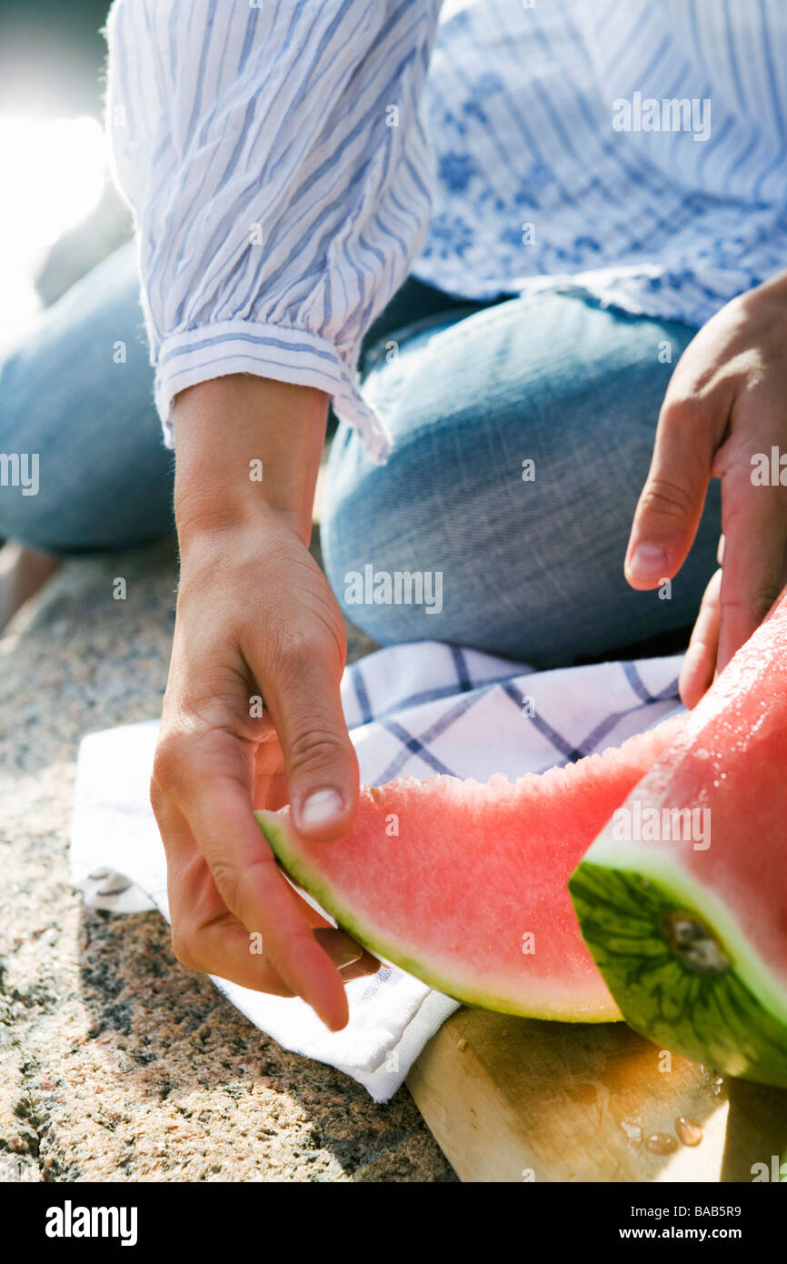 A woman cutting up a watermelon, Sweden Stock Photo - Alamy