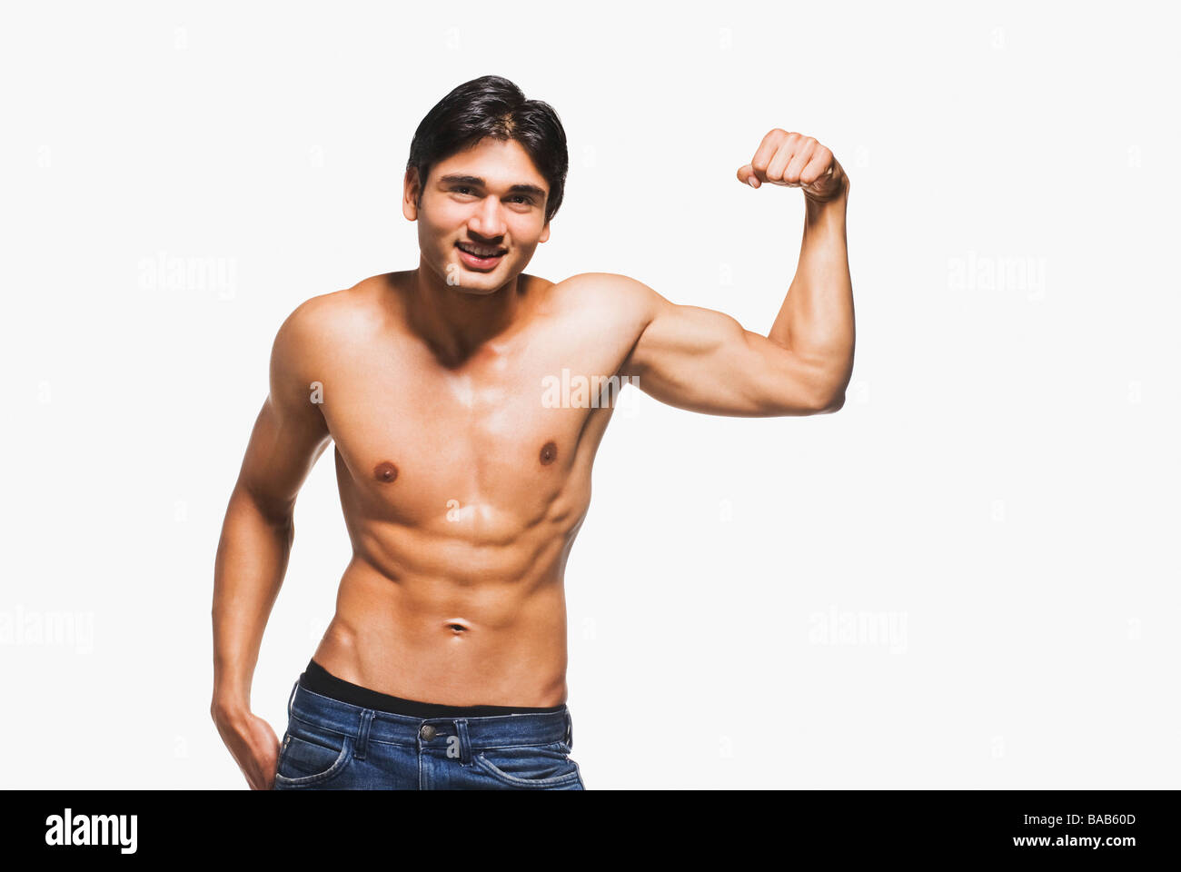 Portrait of a man showing his biceps Stock Photo - Alamy
