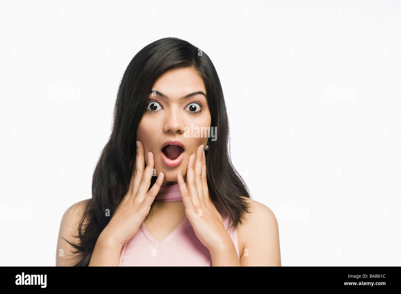 Portrait of a woman looking shocked Stock Photo - Alamy