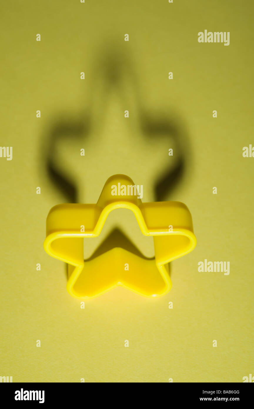 Star shaped cookie cutter of yellow color Stock Photo - Alamy