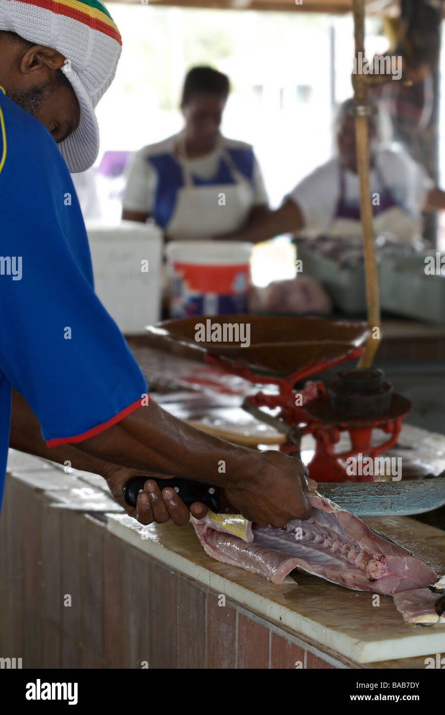 Butcher cutting freshly farmed Kingfish at Oistins Fish Market or now ...