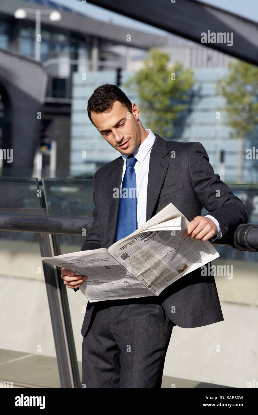 A businessman reading the paper on the airport, Denmark Stock Photo - Alamy