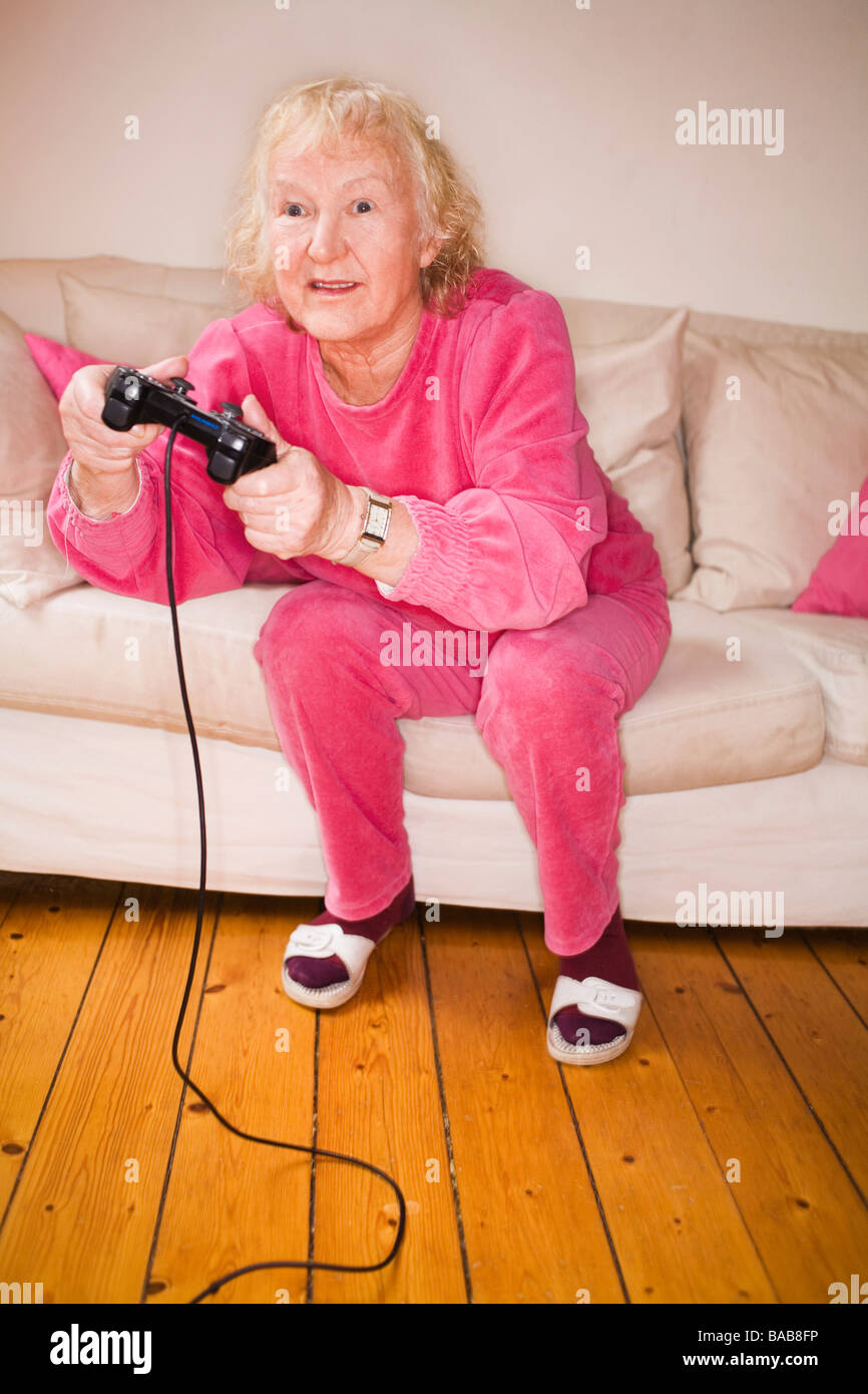 An elderly woman playing a video game Sweden Stock Photo - Alamy