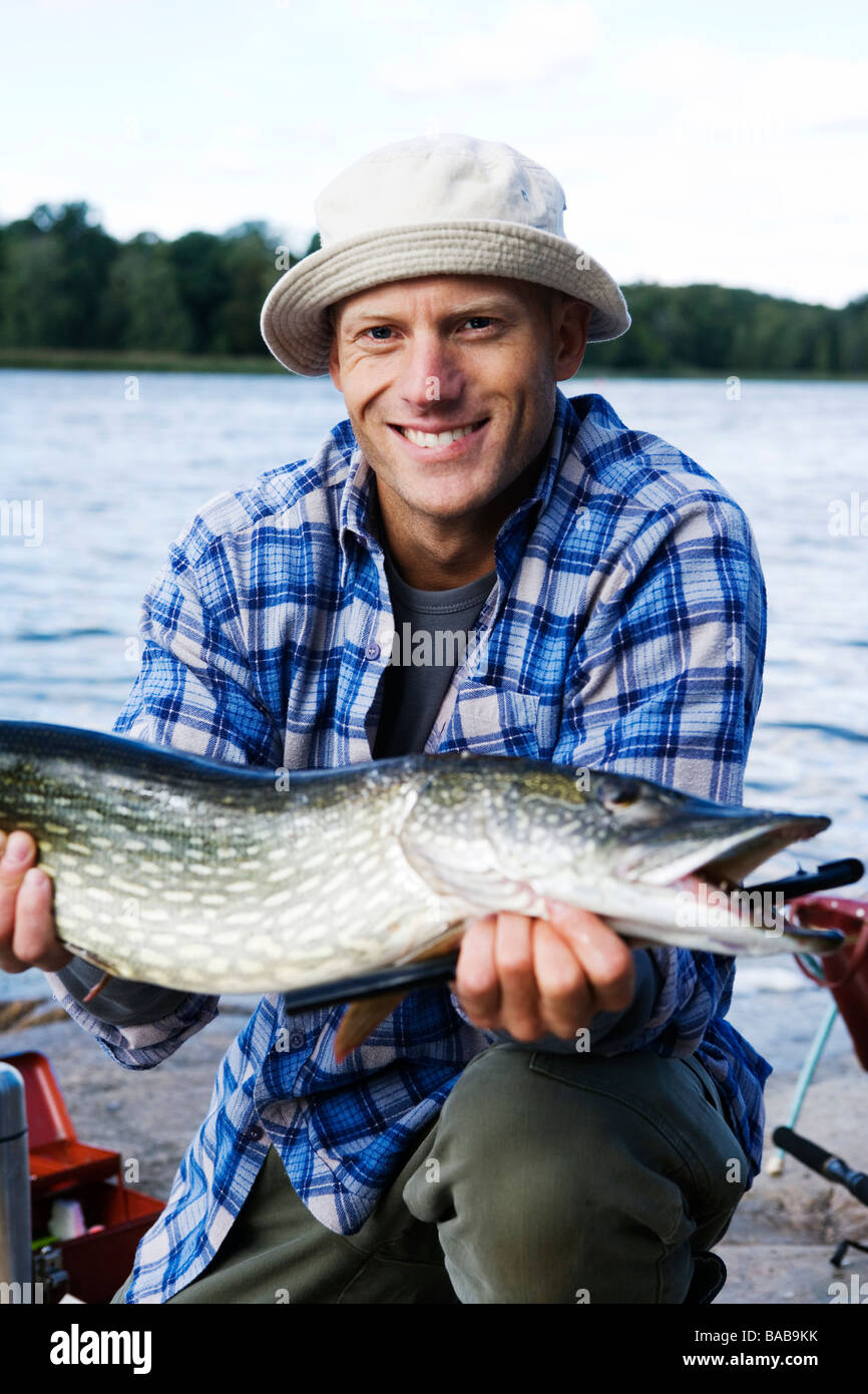 A man holding a pike Sweden Stock Photo - Alamy