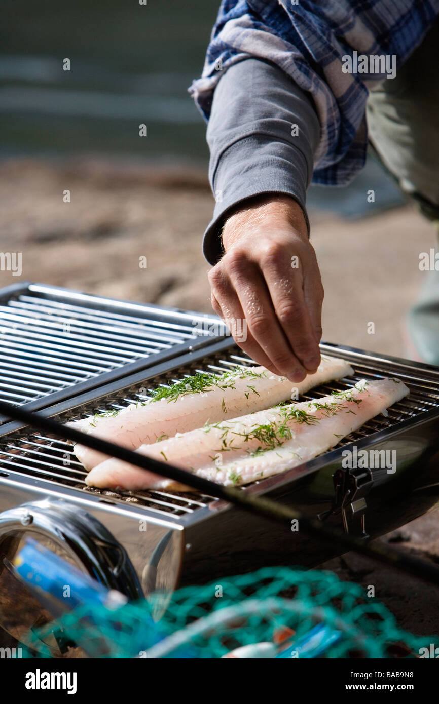 Mature man grilling fish hi-res stock photography and images - Alamy