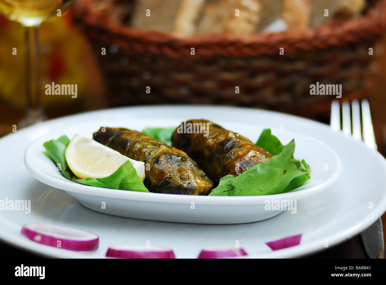 traditional turkish food, dolma on the plate with onion and lemon Stock ...