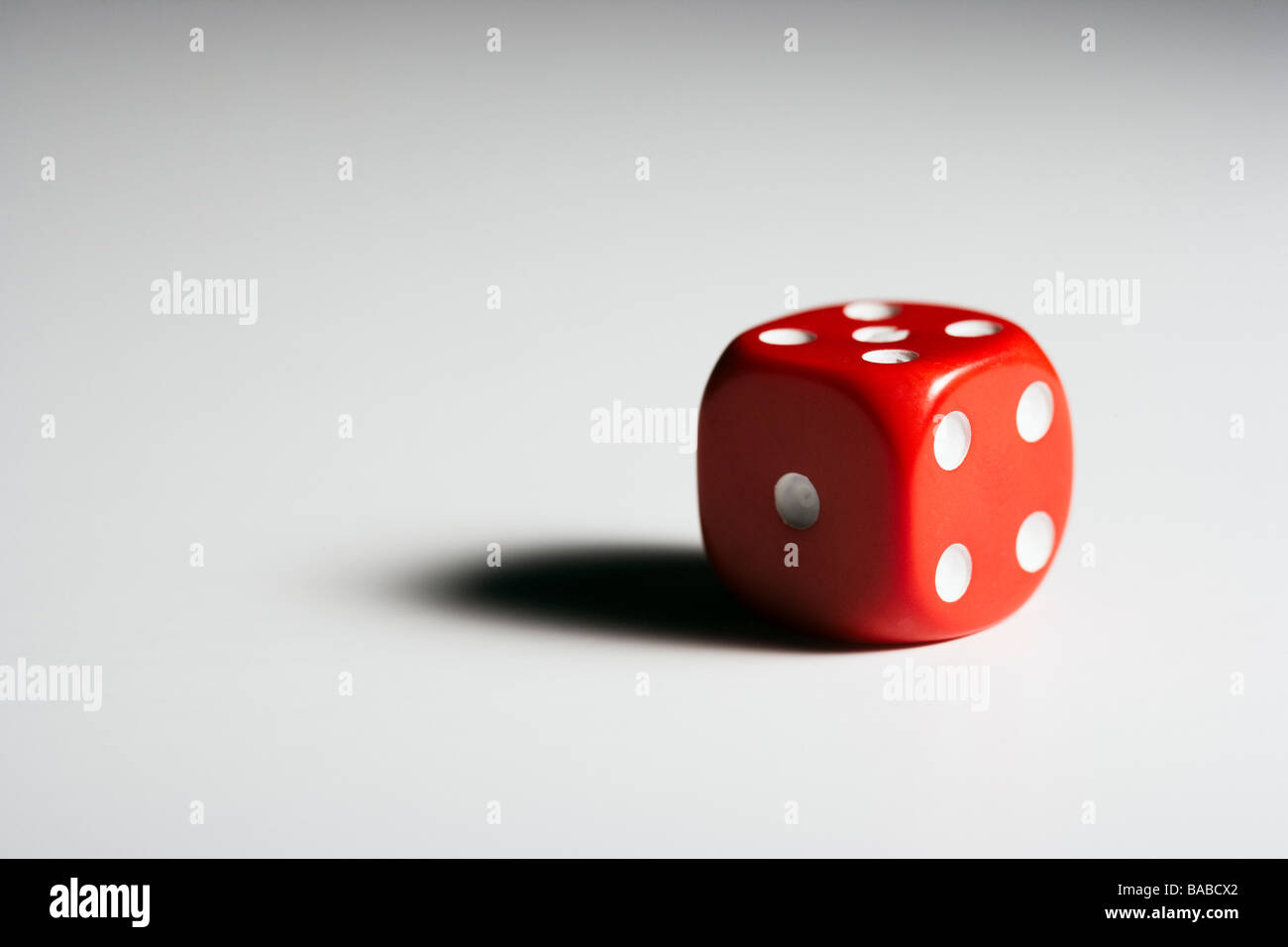 A red dice against white background Stock Photo - Alamy
