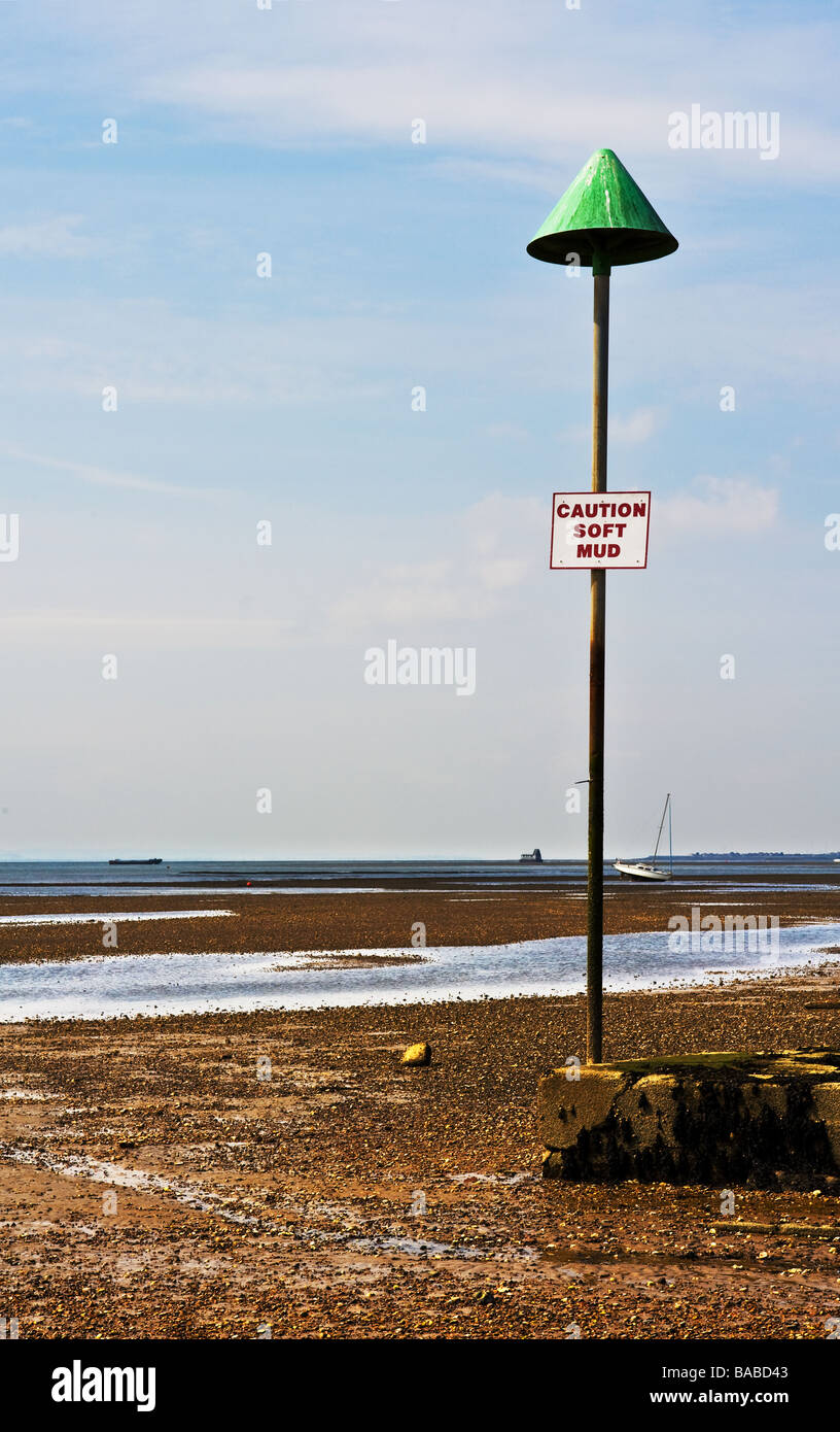 A warning sign on a pole on the beach at Southend on Sea in Essex ...
