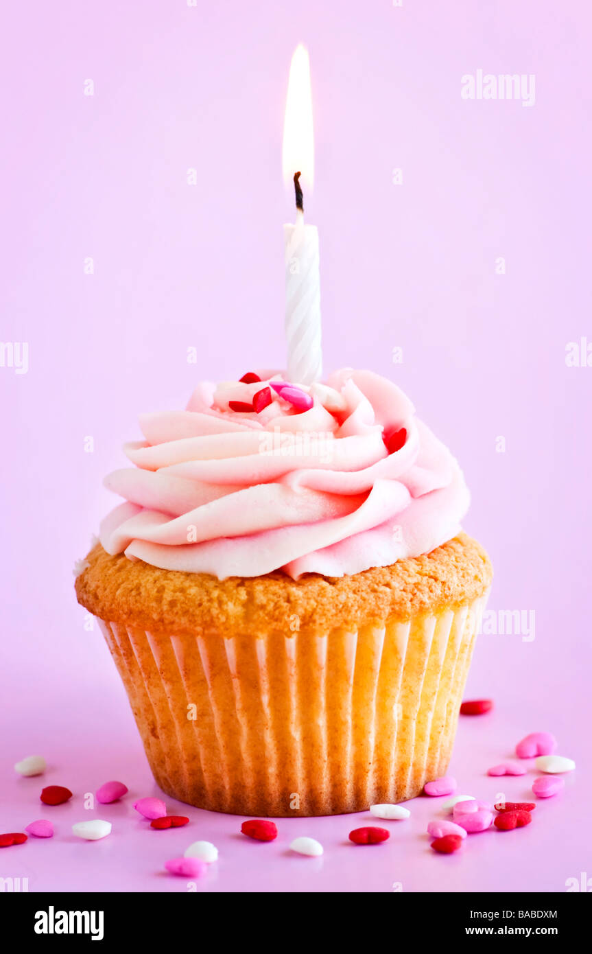Single cupcake with icing sprinkles and candle Stock Photo - Alamy