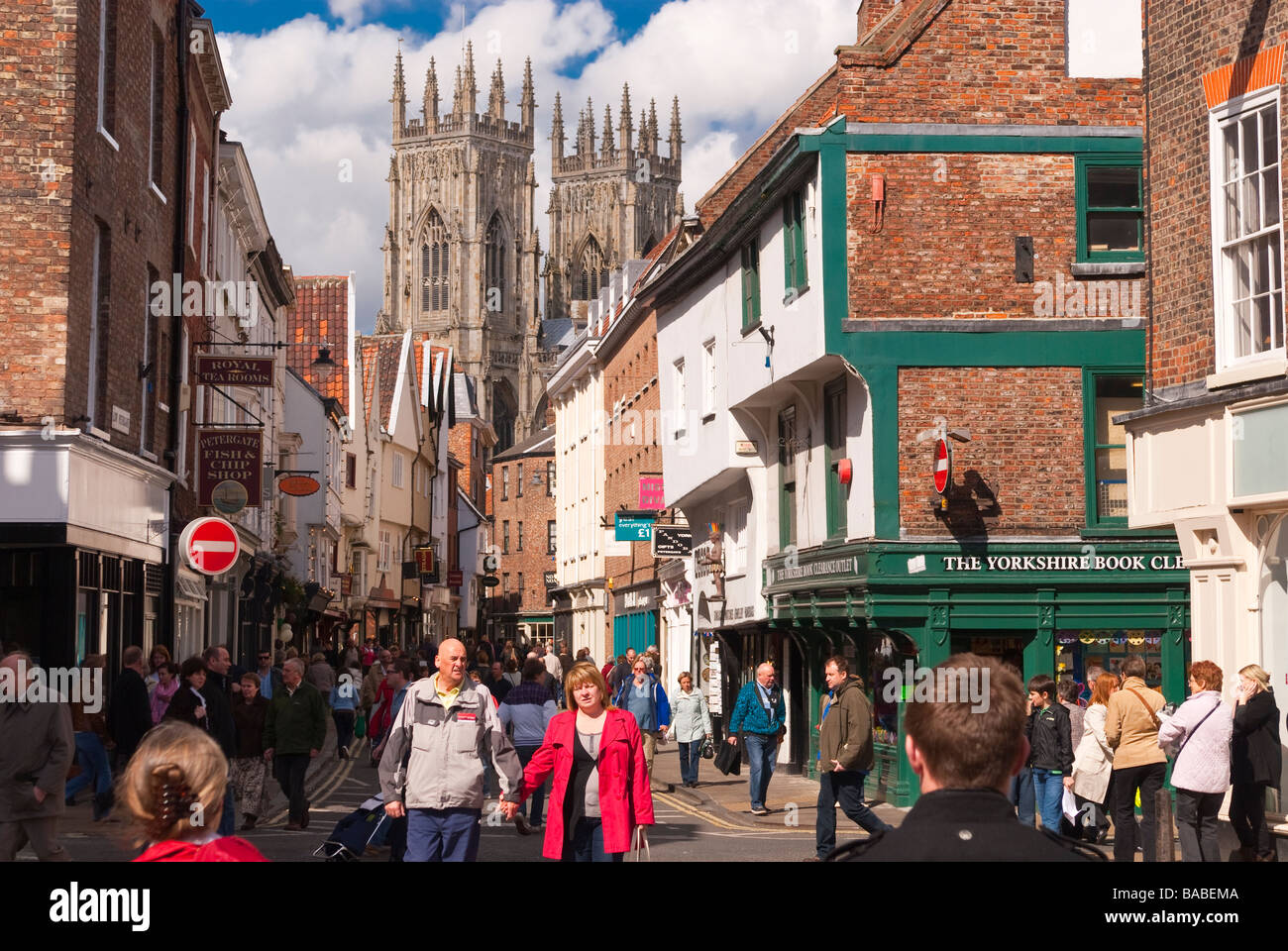 Shoppers in the streets of York,Yorkshire,Uk with the York Minster ...