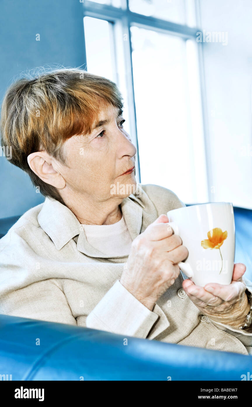 Lonely sad woman drinking tea hi-res stock photography and images - Alamy