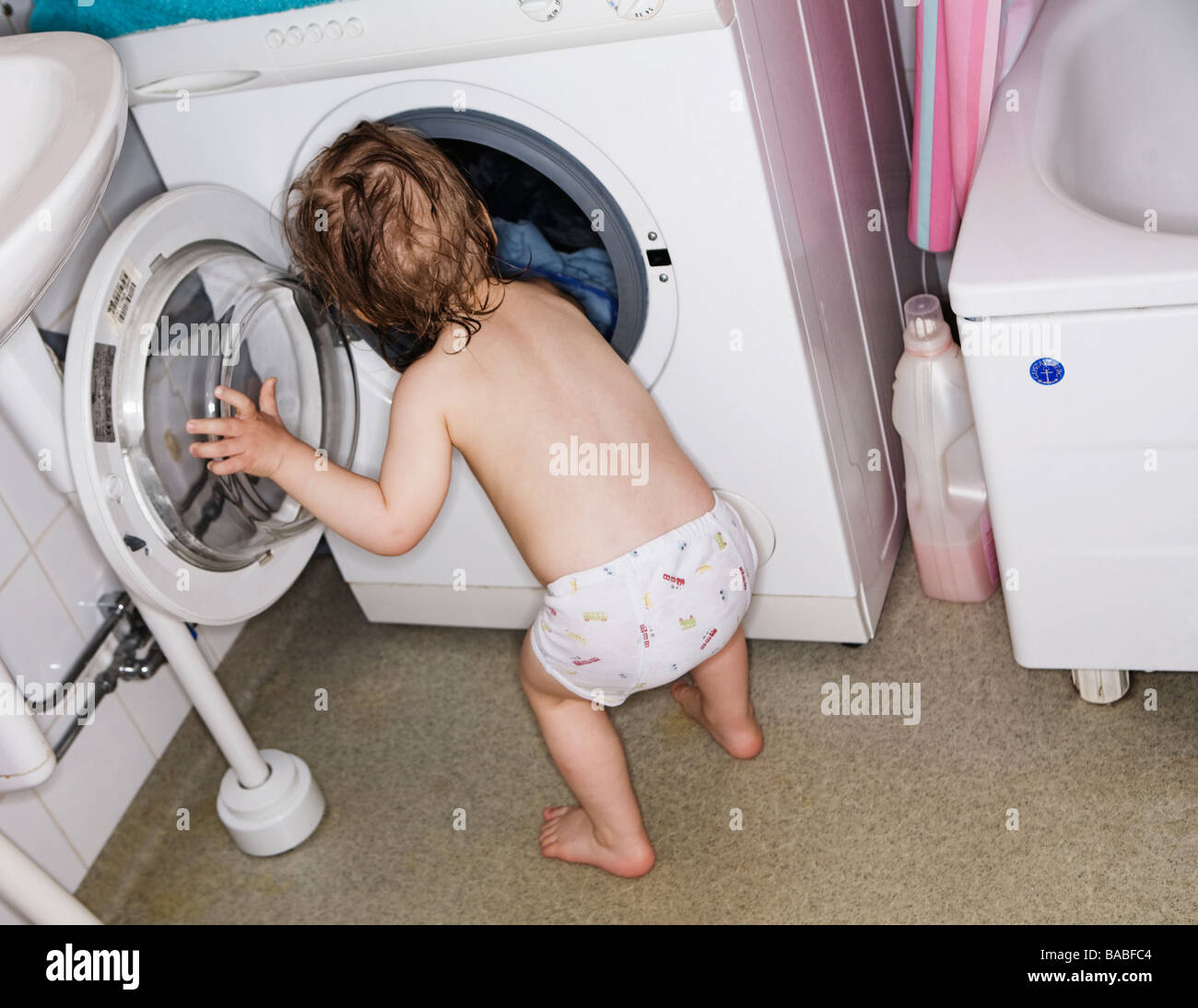 Boy doing laundry Sweden Stock Photo - Alamy