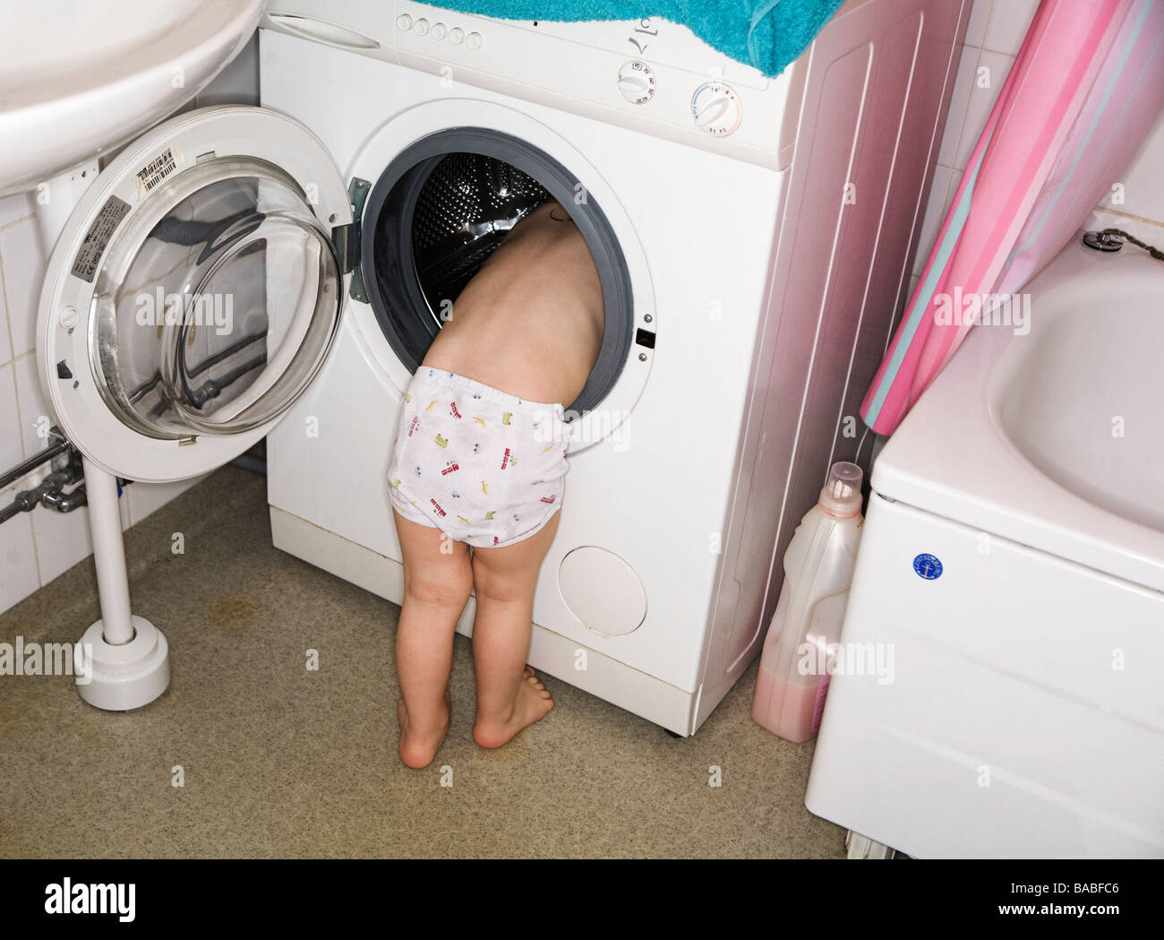 Boy doing laundry Sweden Stock Photo - Alamy