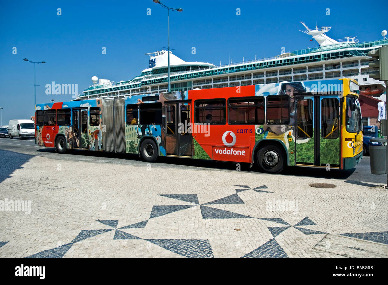 The cruise ship Legend of the Seas towers above a shuttle bus which ...