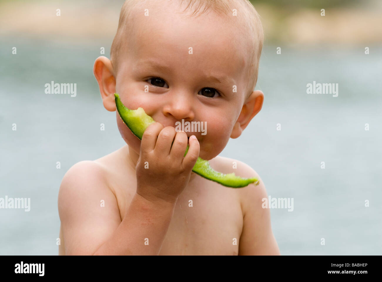 A litttle child eating melon Sweden Stock Photo - Alamy