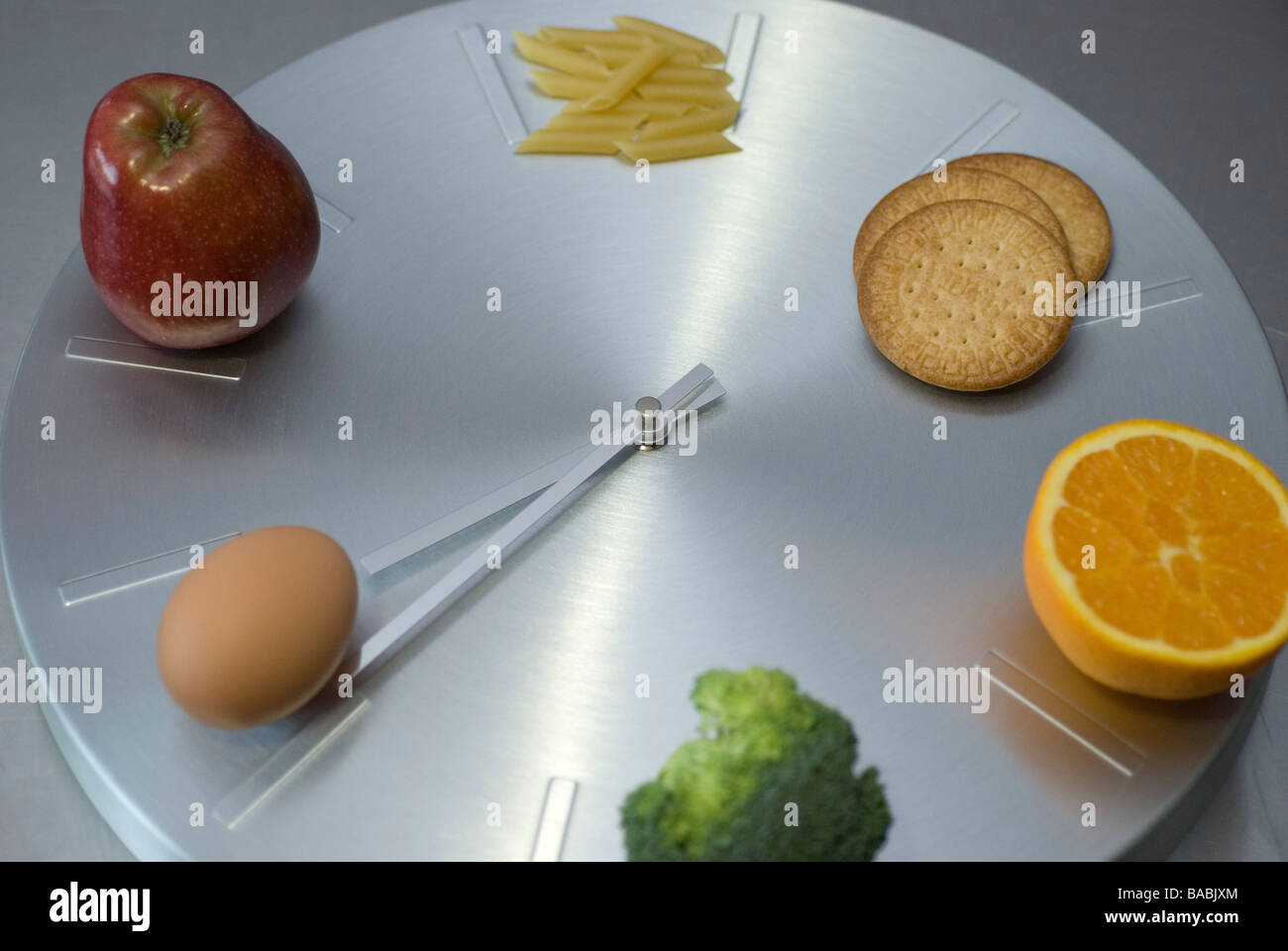 clock food control- pasta, biscuits, orange, apple, egg and broccoli ...