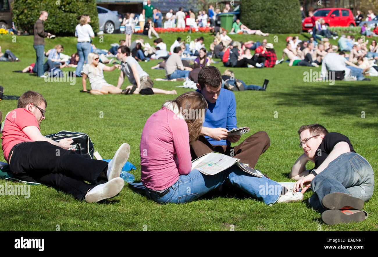 People enjoying a bright spring day on a lawn in Glasgow's Botanic ...