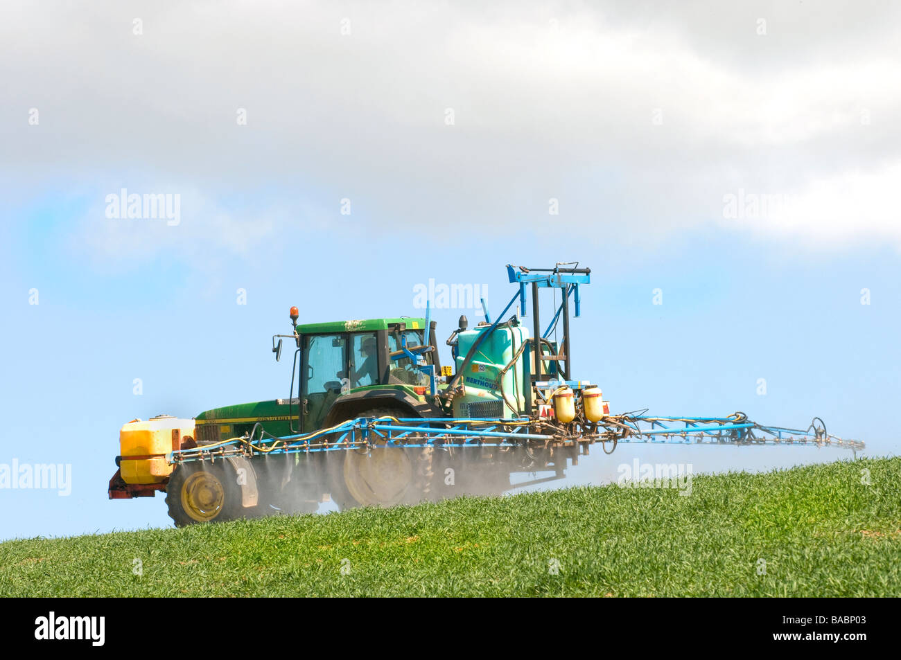 Springtime crop spraying with tractor in rural Devon field near ...
