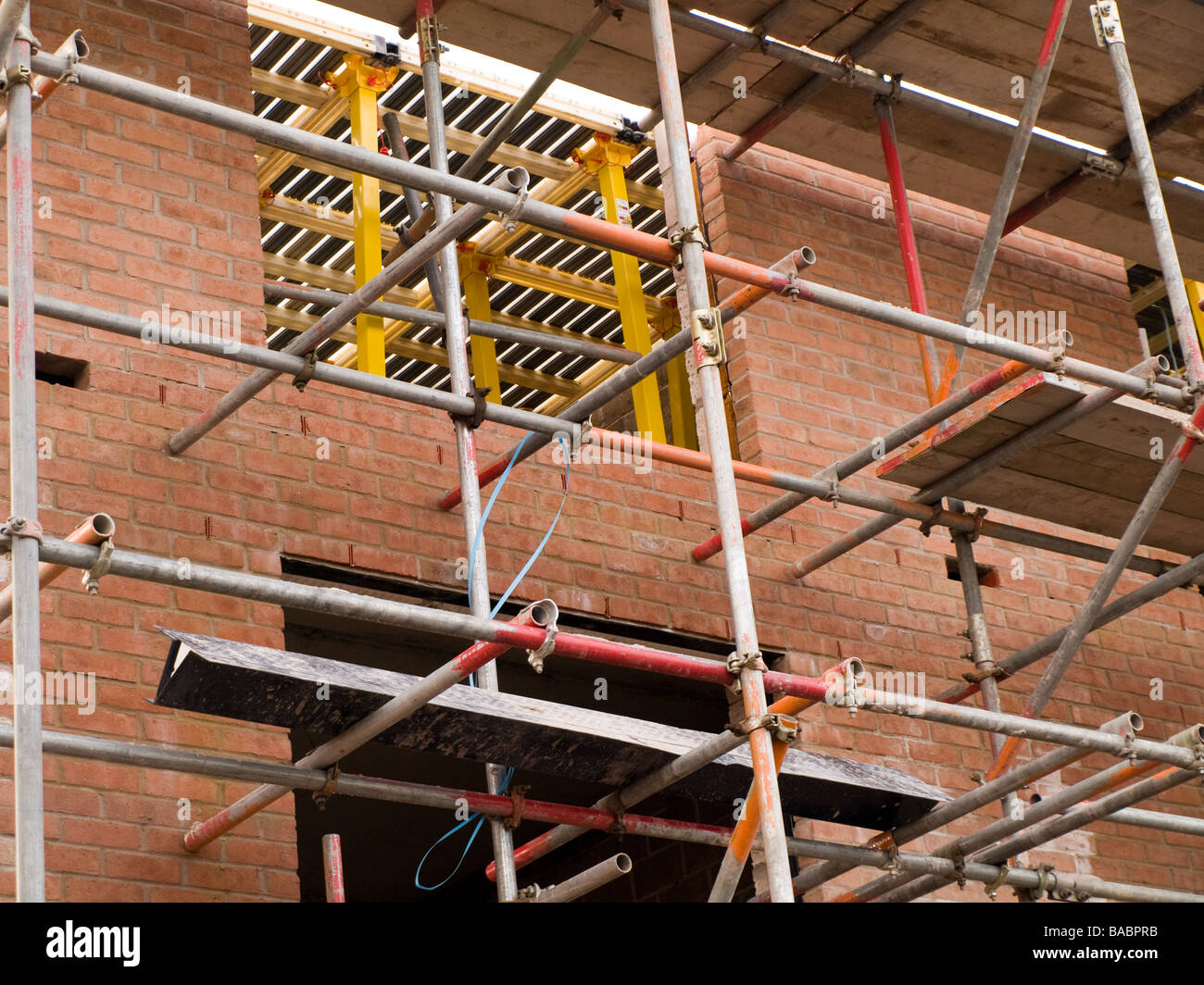 Construction Site with Scaffolding and New Build Red Brick Houses Stock ...